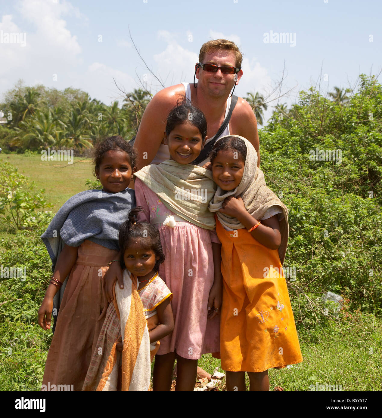 Tourist posing with local Children, Goa, India Stock Photo - Alamy