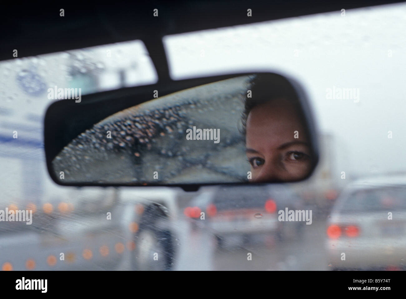 Rush hour traffic looking through windshield at cars break lights in ...
