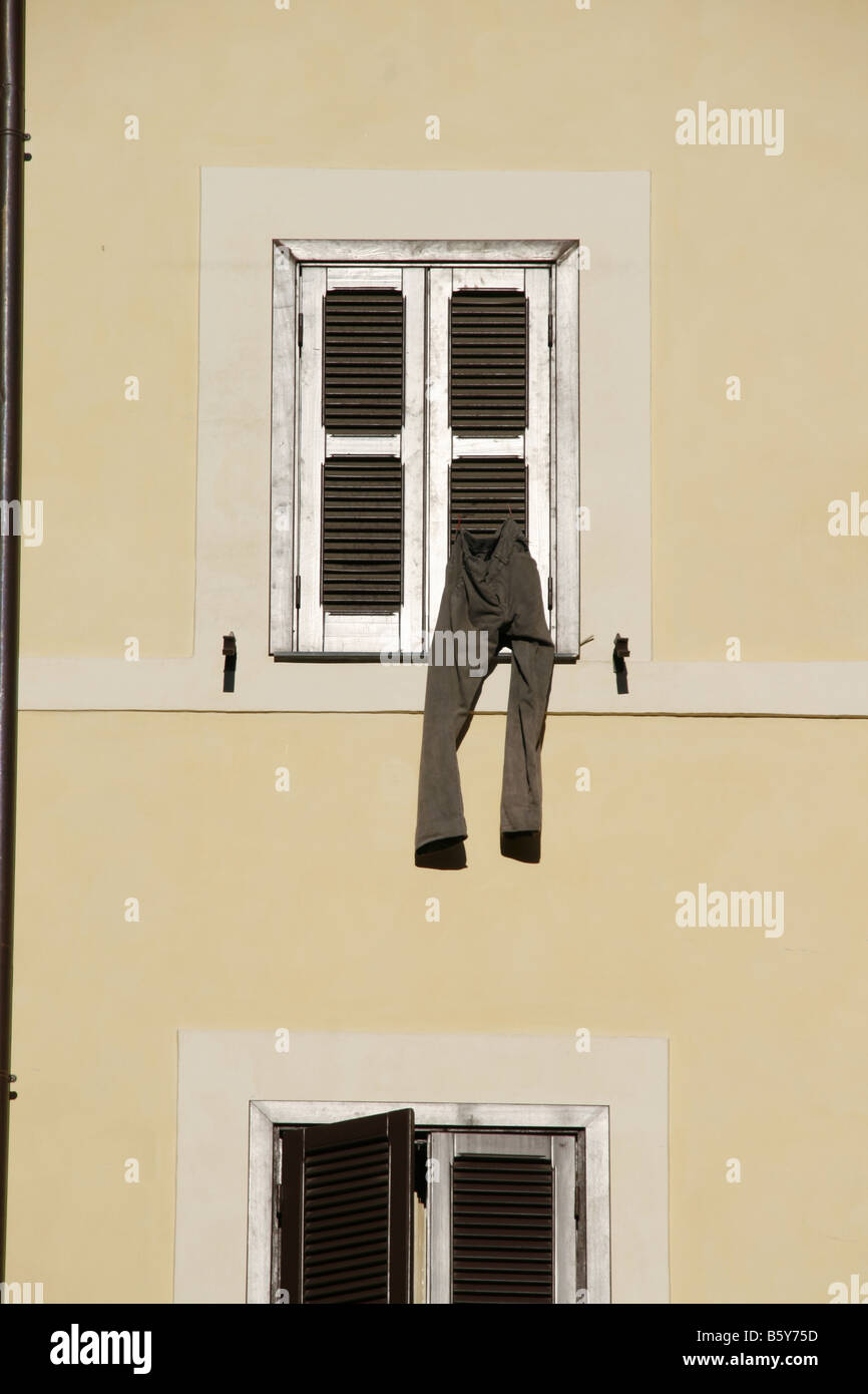 pair of green trousers on washing line outdoors in sun in italy Stock ...