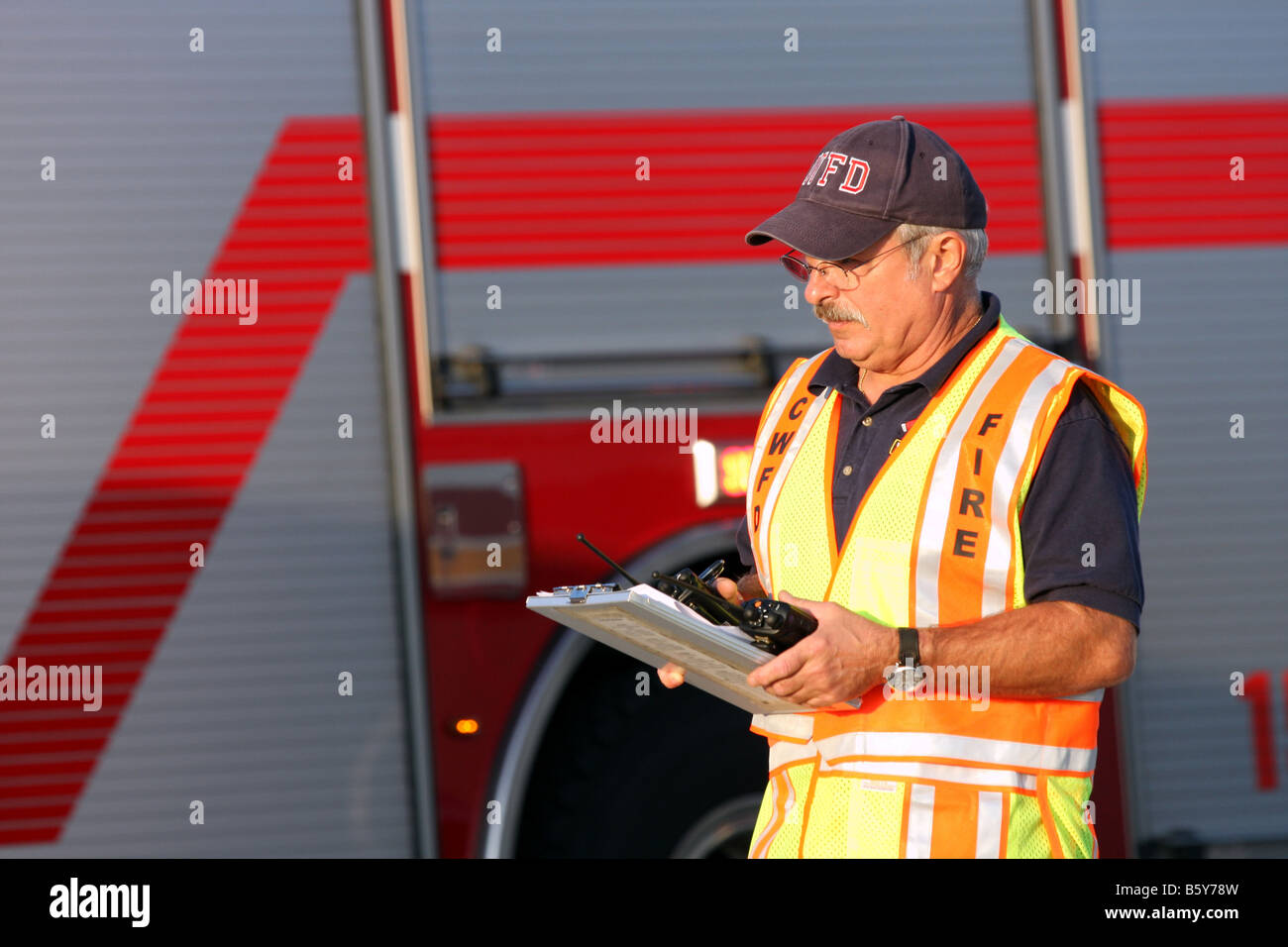 A Fire department personnel with a clip board and radio at a mass ...