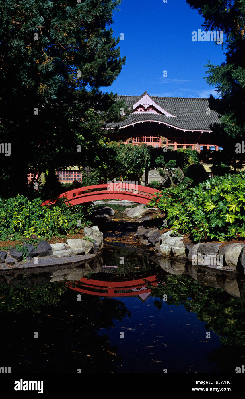 Japanese Garden with small red walking bridge across small pond Point ...