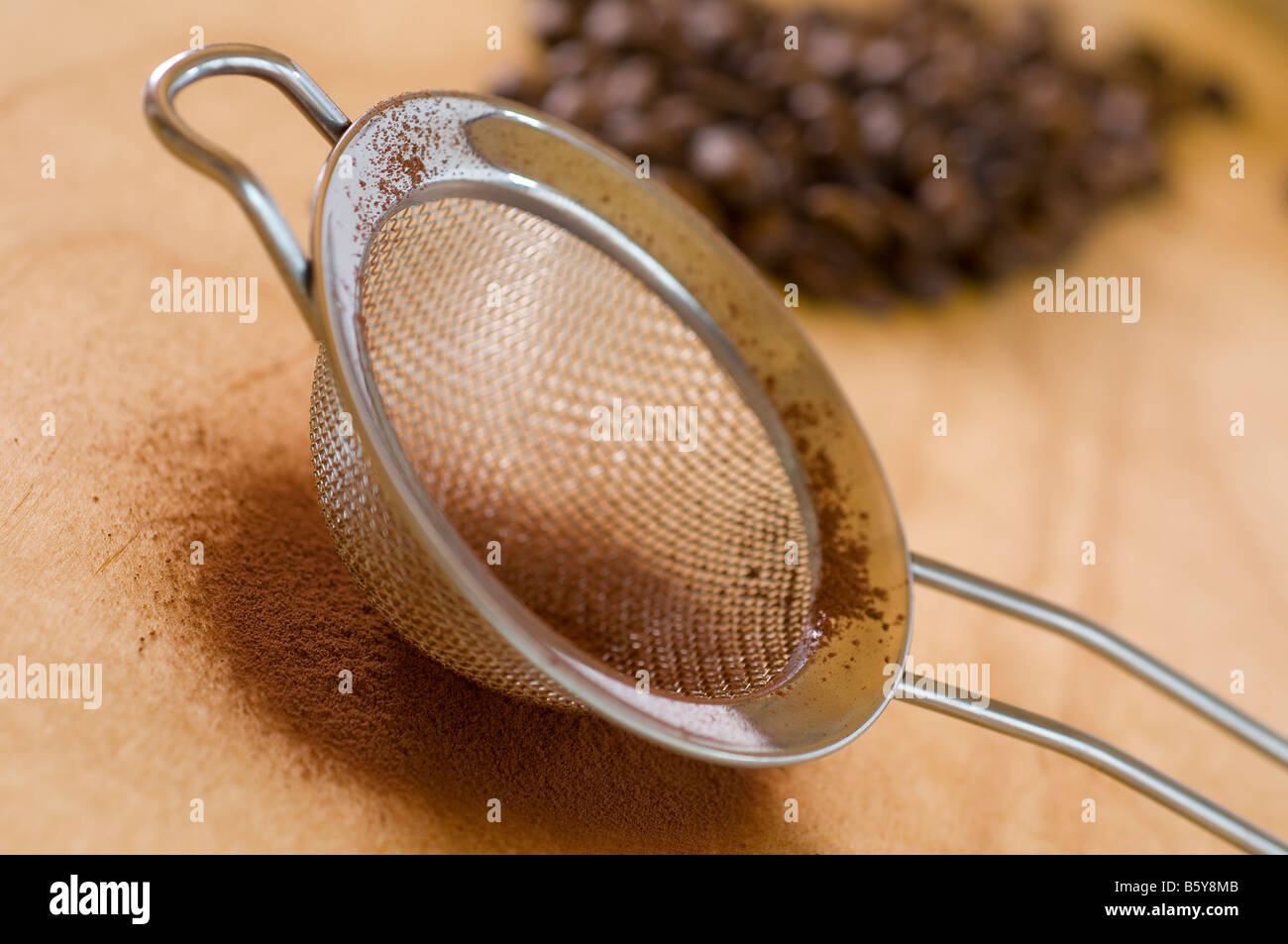 stainless steel filter with cocoa powder on wood Stock Photo - Alamy