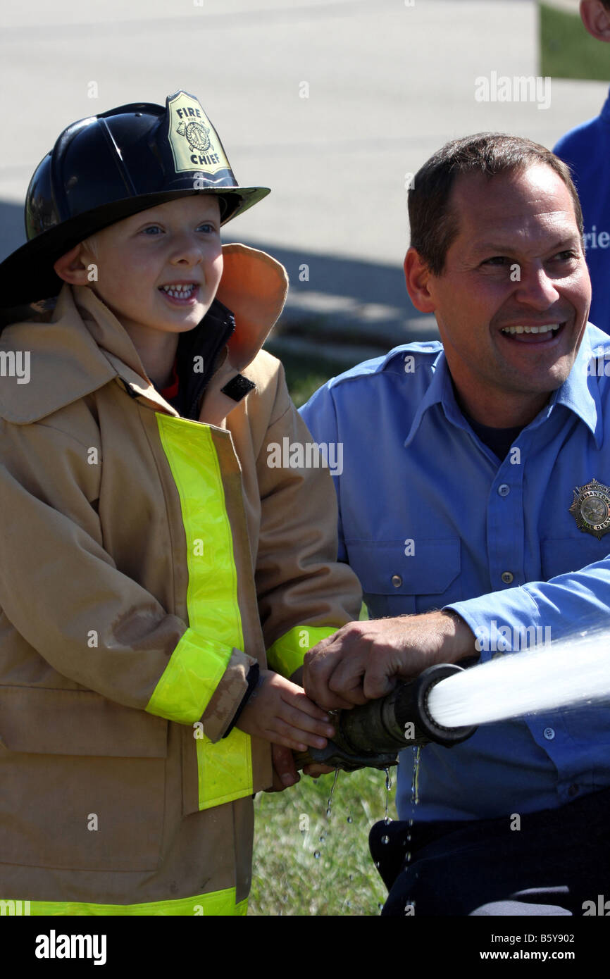 Firemen using hose hi-res stock photography and images - Alamy