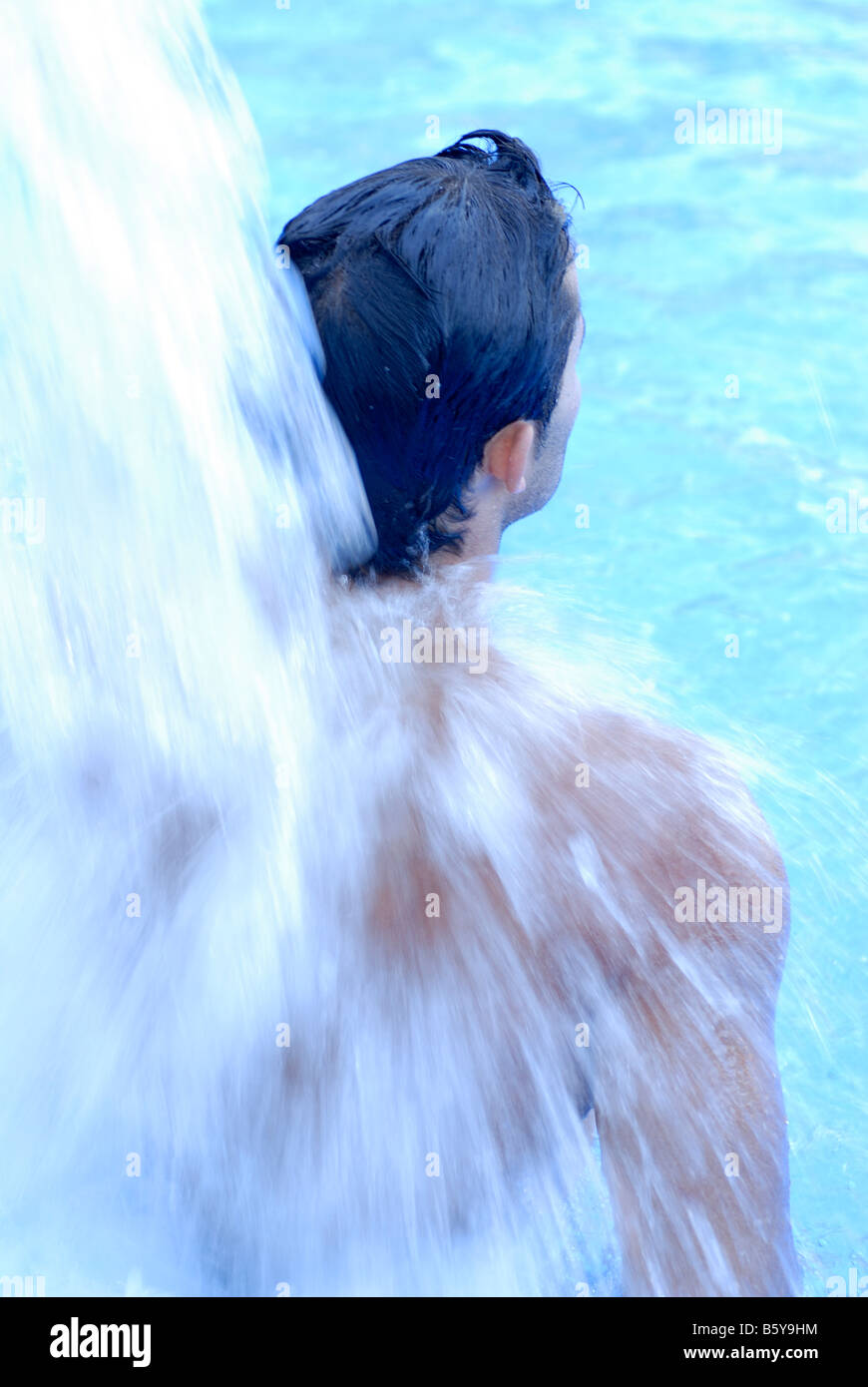 Man in fountain or shower Swimming pool Spa relaxing men´s health ...