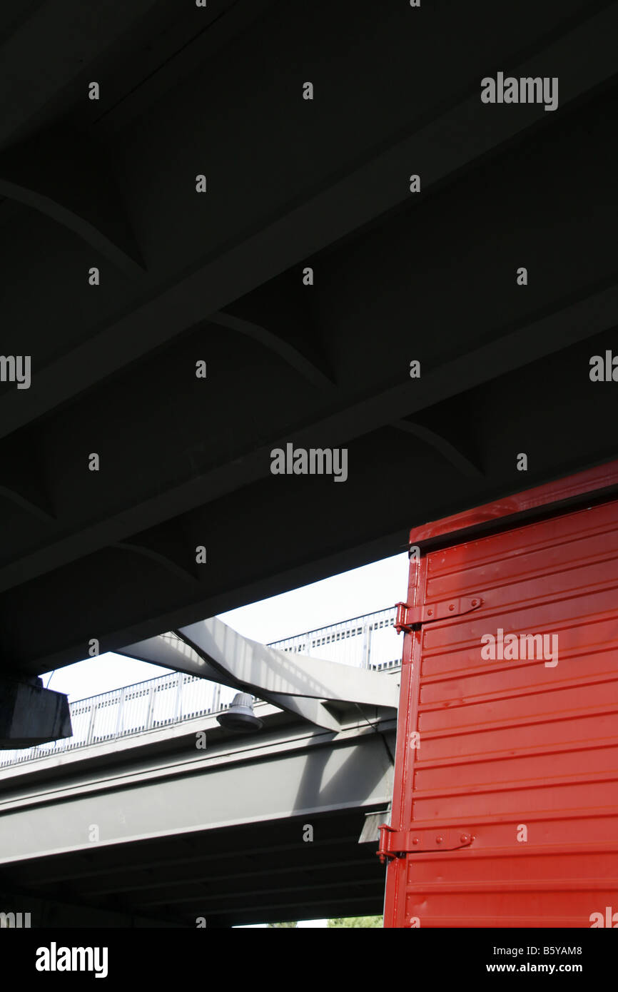 one red lorry truck under flyover bridge in town Stock Photo - Alamy