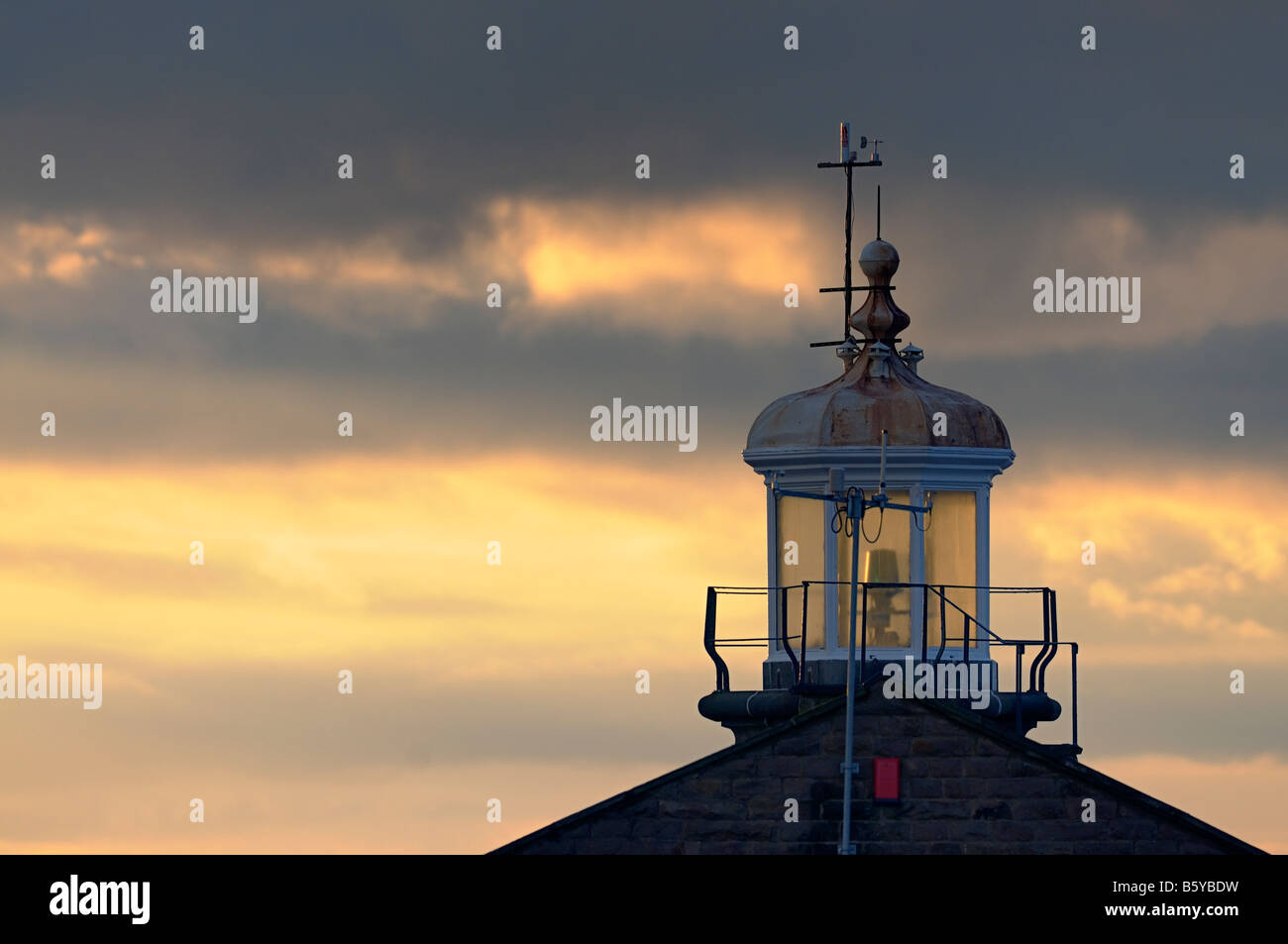 A harbour light at sunset Stock Photo - Alamy
