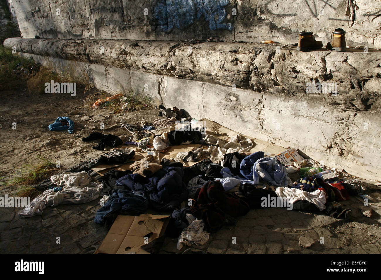 pile of old clothes garments left on street road Stock Photo - Alamy