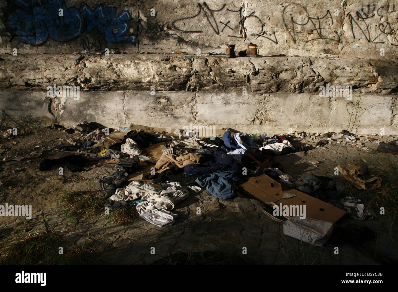 pile of old clothes garments left on street road Stock Photo - Alamy