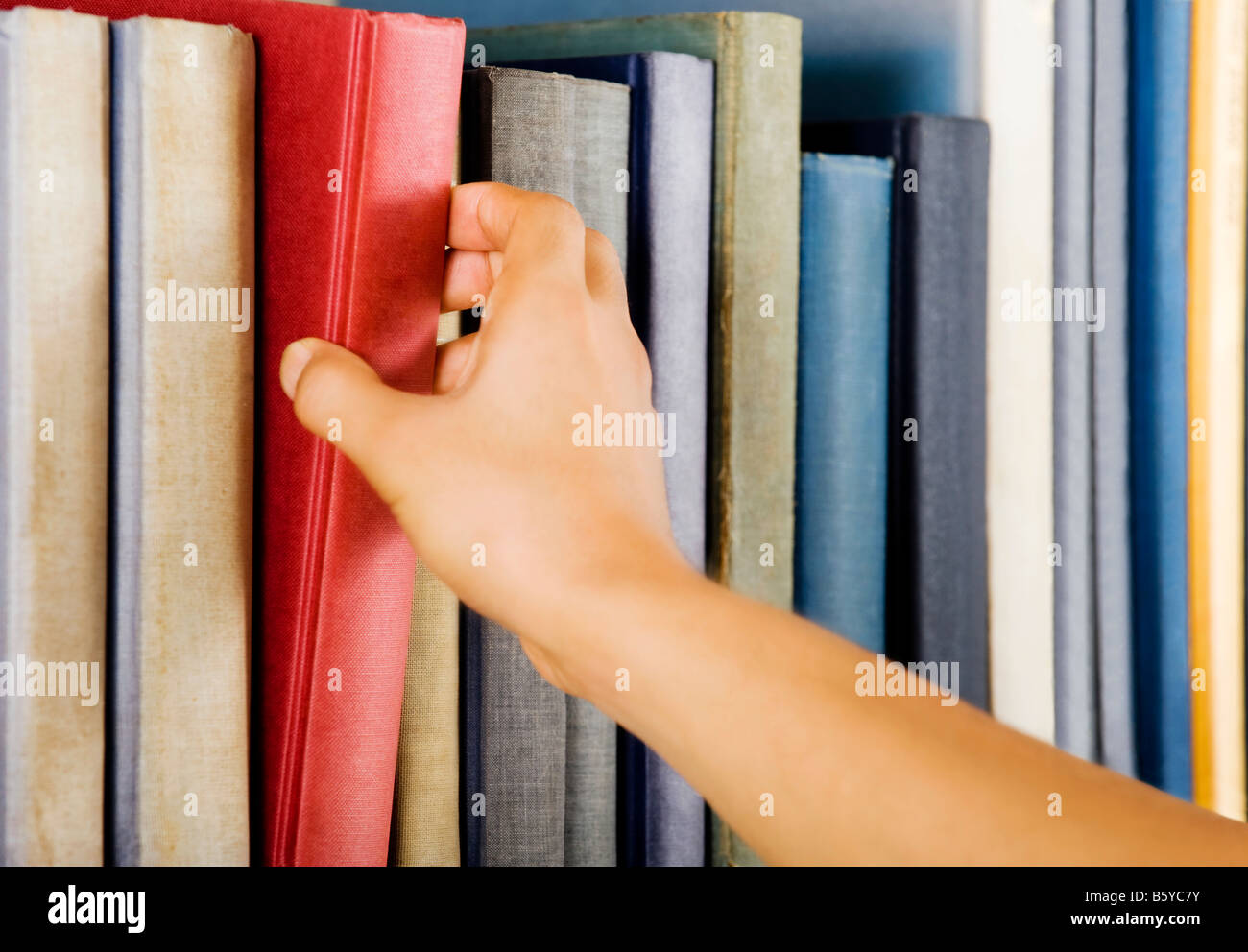 Selecting a book Stock Photo - Alamy