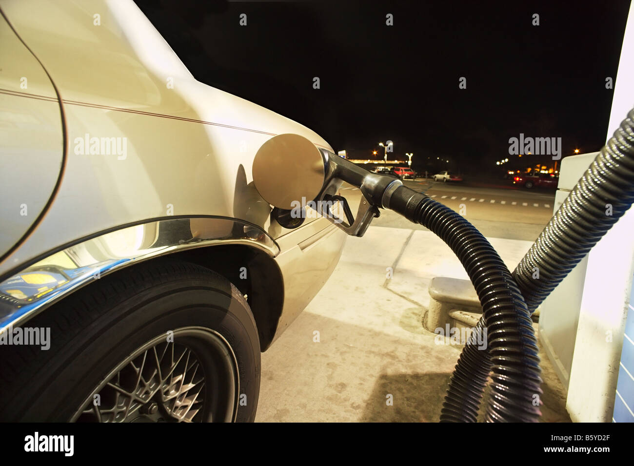 Large car being filled with gasoline Stock Photo - Alamy