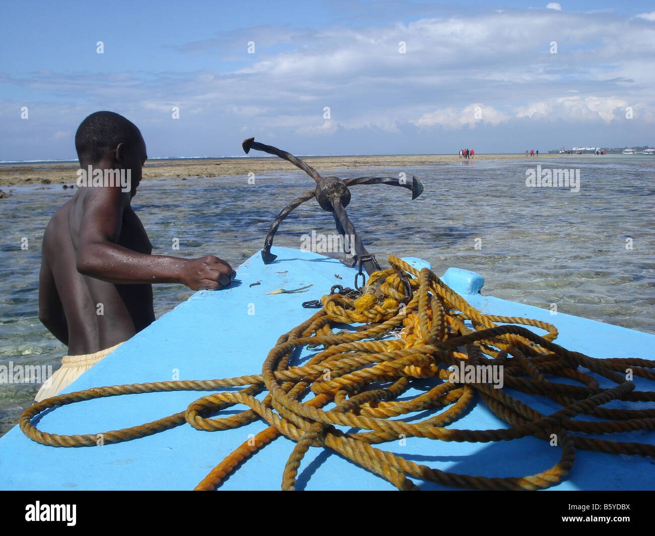 Man and fishing boat off the coast of Mombasa, Kenya Stock Photo - Alamy
