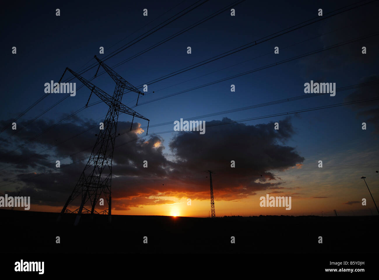High Voltage power lines at sunset Stock Photo - Alamy