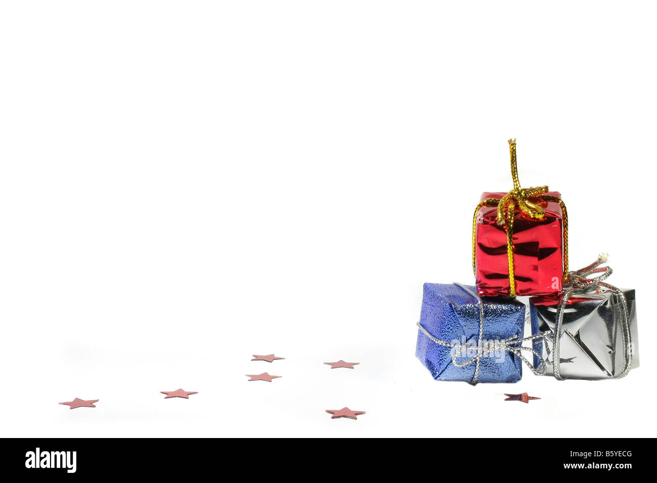 Boxes of gifts and tiny red stars isolated over white background Stock ...