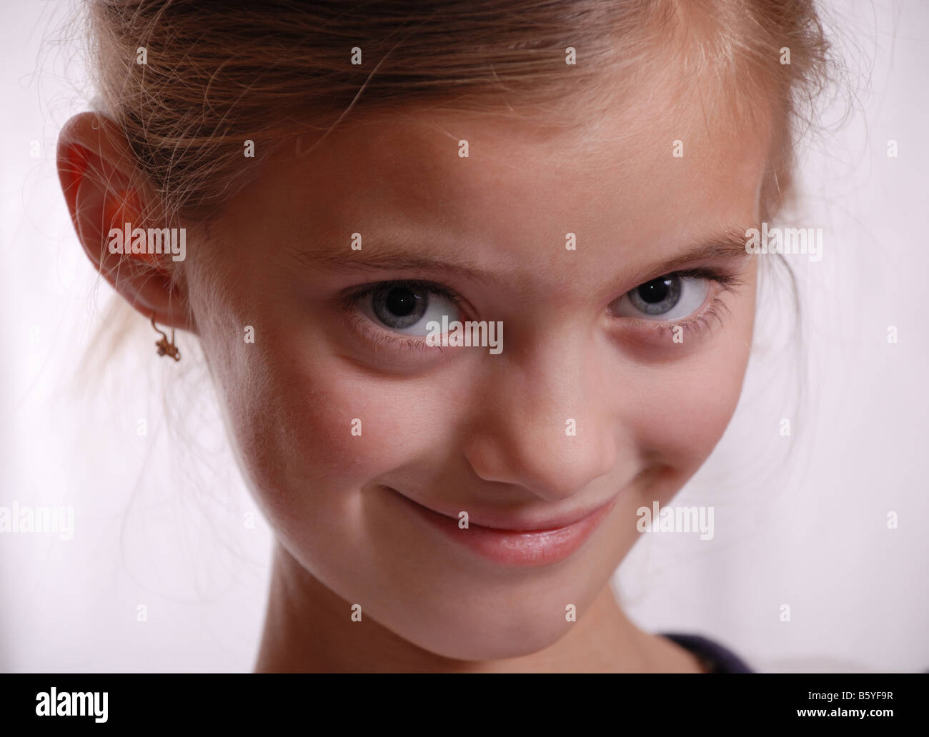 Portrait of child with amicable sight pure gray eyes sharp face slim ...