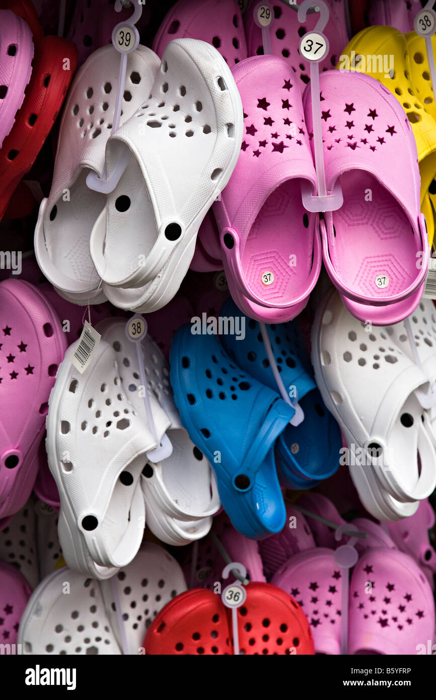 Plastic shoes on rack Germany Stock Photo - Alamy