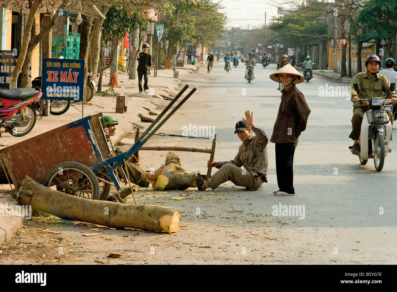 Vietnam scene street people men lifestyle loaded poor Stock Photo - Alamy