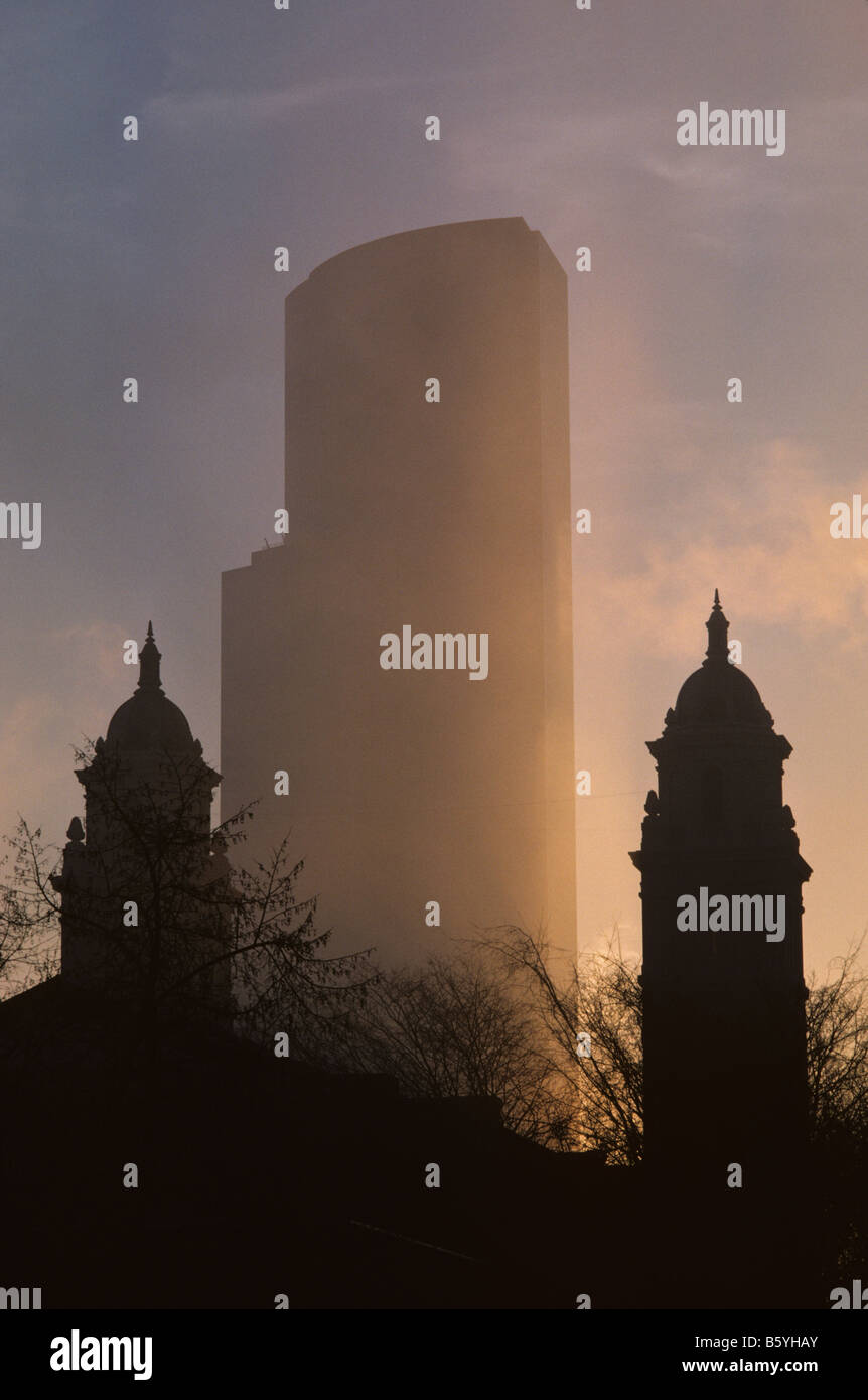 Office building at sunset in fog with Saint James Cathedral Steeples ...