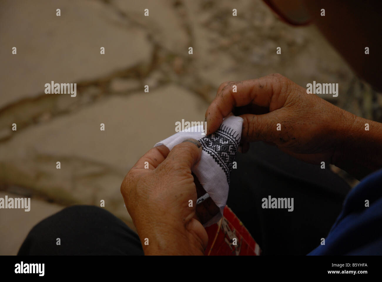 A woman with her needle work in an ethnic Dong village in rural Guizhou ...