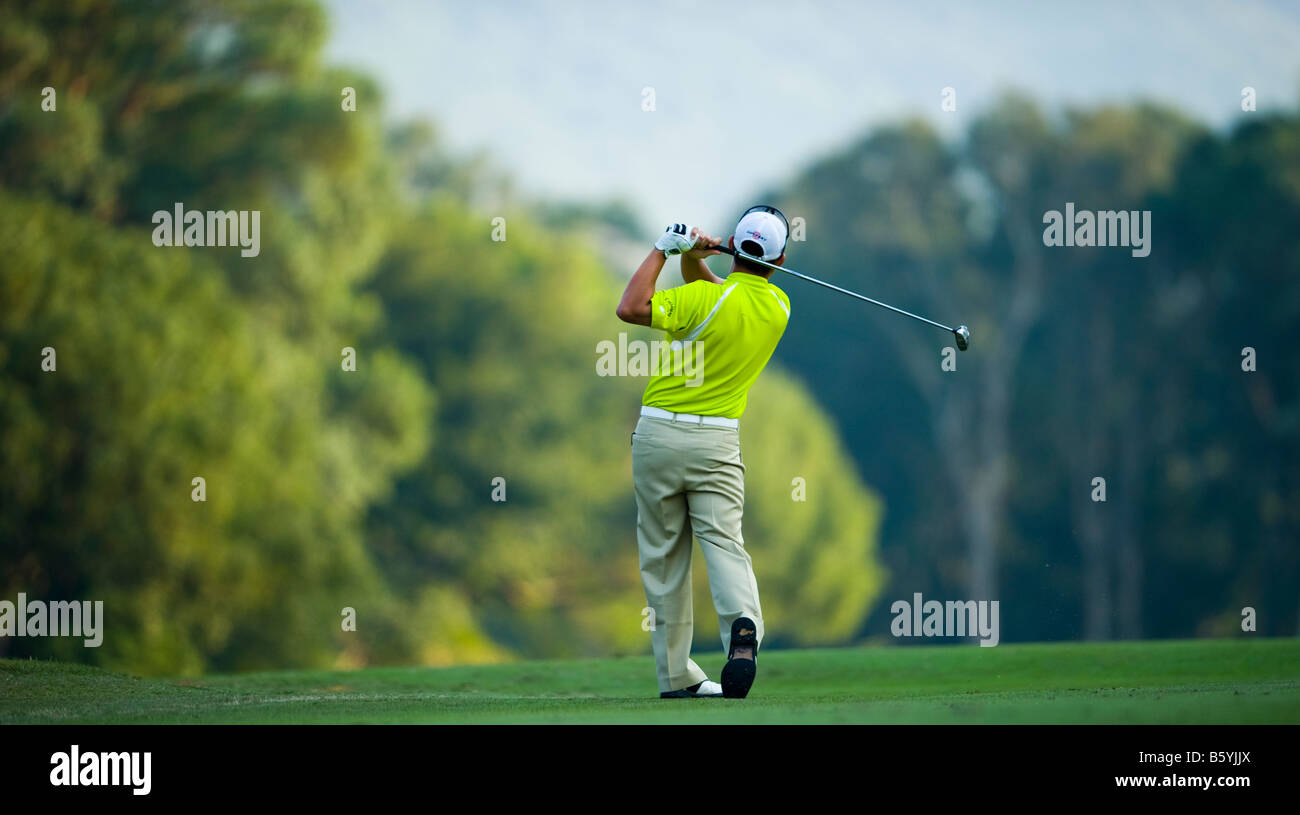 Angelo Que of Philippines competes watches his tee shot during the 50th ...