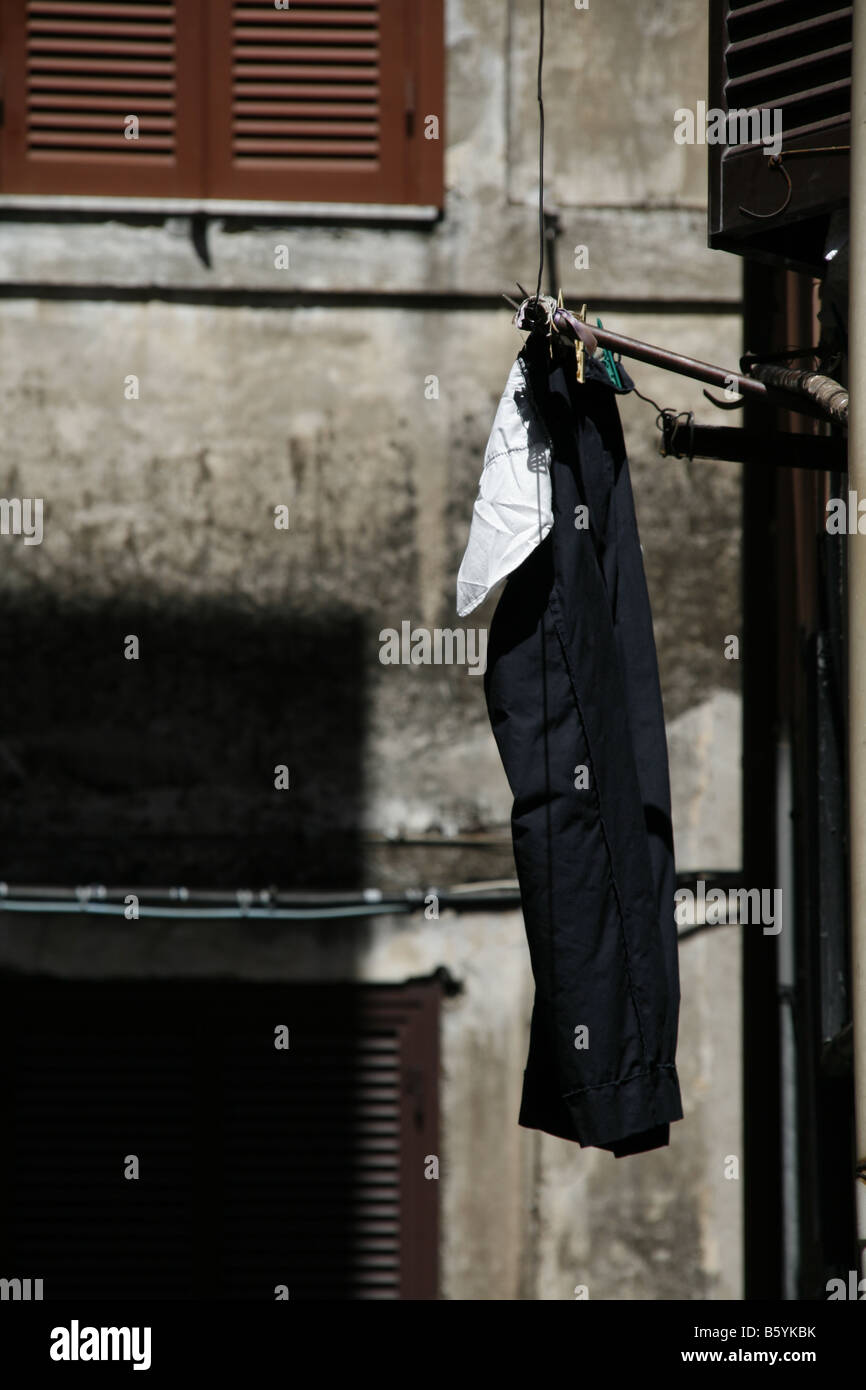 black trousers on washing line outdoors in sun in italy Stock Photo - Alamy