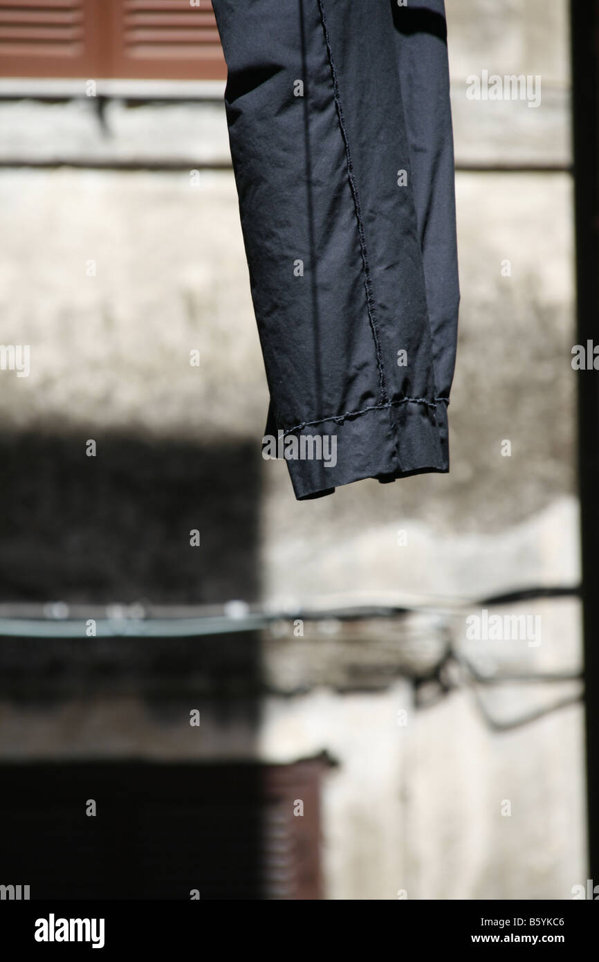 black trousers on washing line outdoors in sun in italy Stock Photo - Alamy