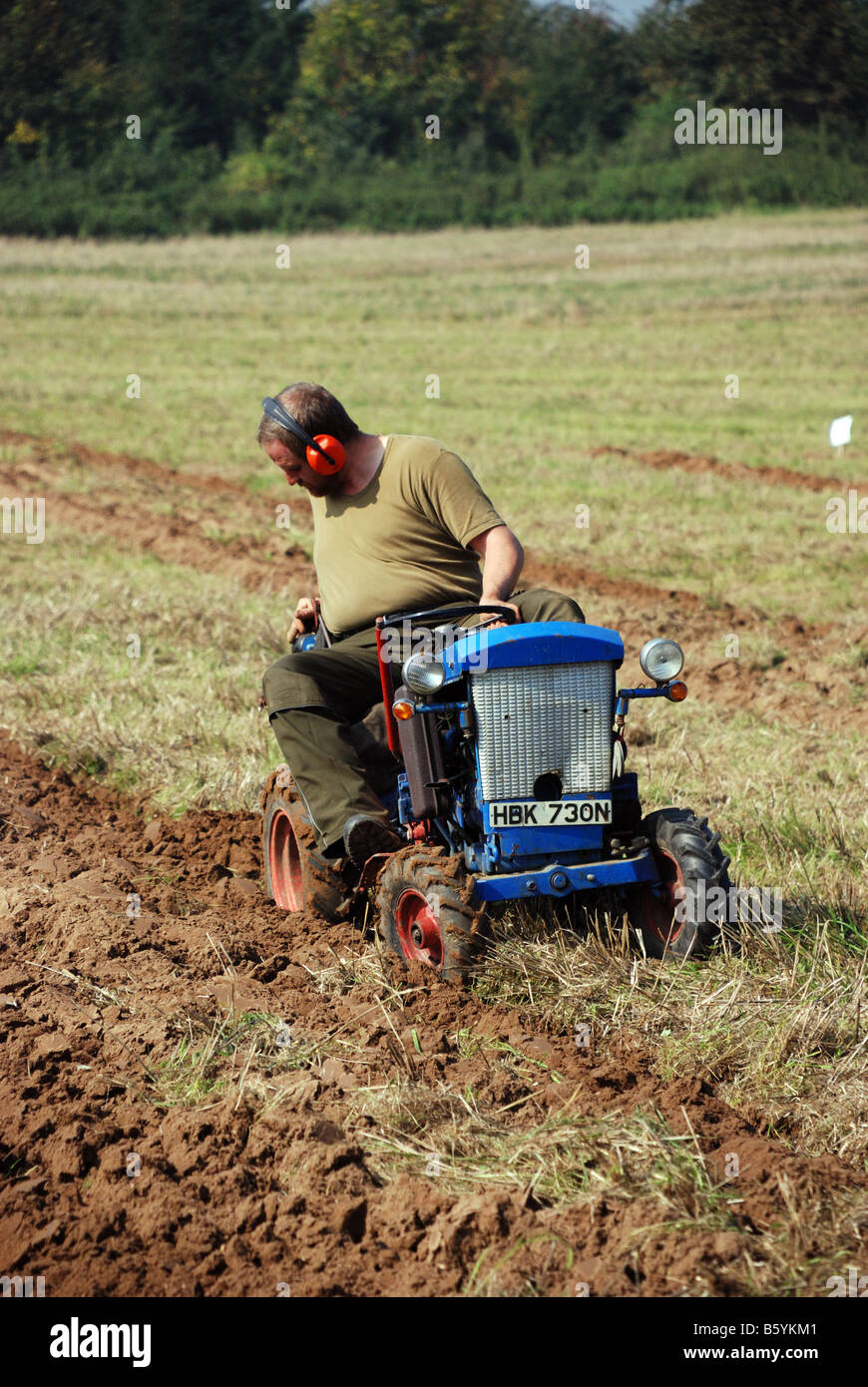 Vintage small sit on tractor plough registration number HBK 730N at the ...