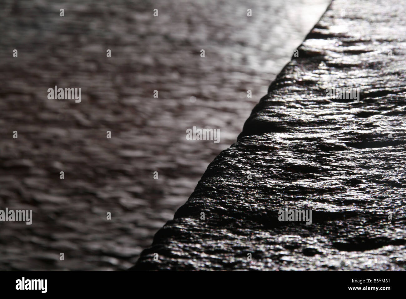 detail of dark damp wet stone wall in alley way at night Stock Photo ...