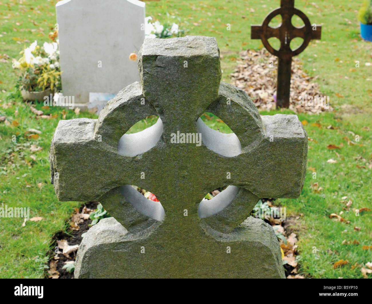 a stone cross in a cemetery Stock Photo - Alamy