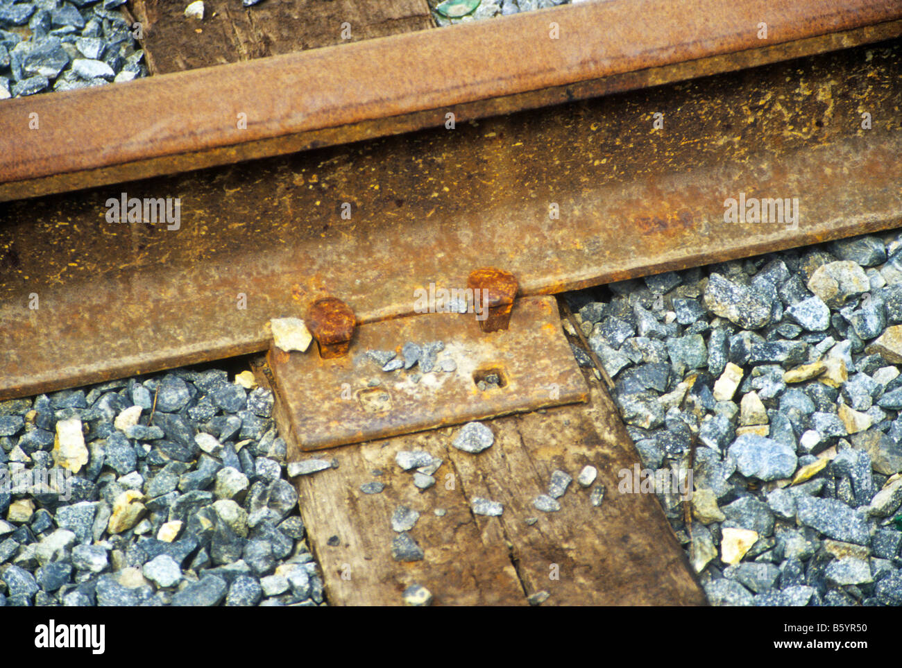 Rusty railroad track and metal hold-down device Stock Photo - Alamy