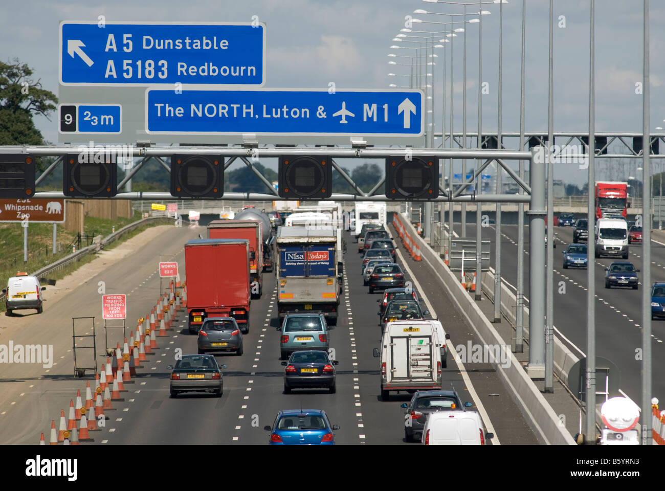 Queues of traffic travelling along the busy m1 motorway in the uk Stock ...