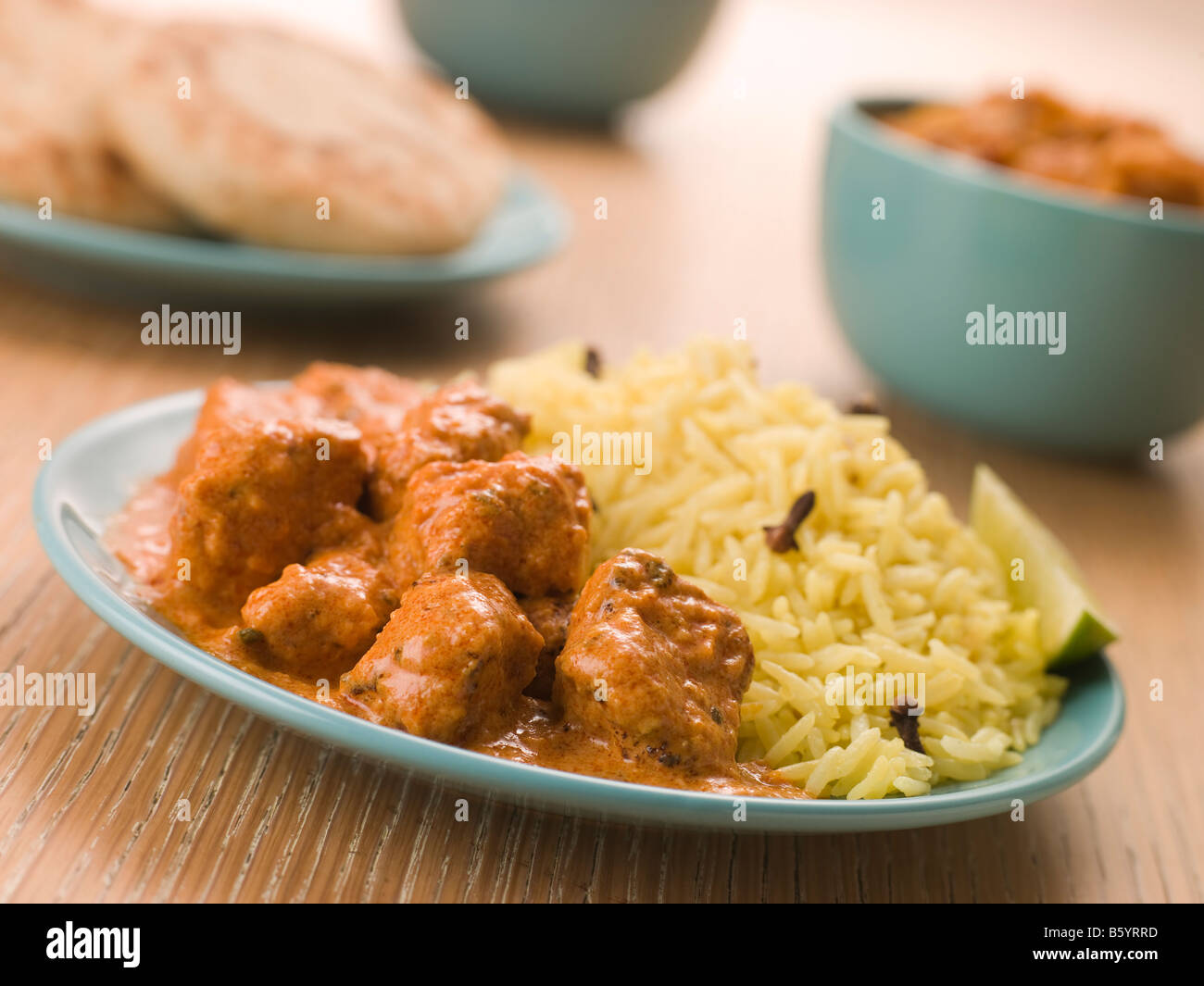 Plated Chicken Korma with Pilau Rice and Naan bread Stock Photo - Alamy