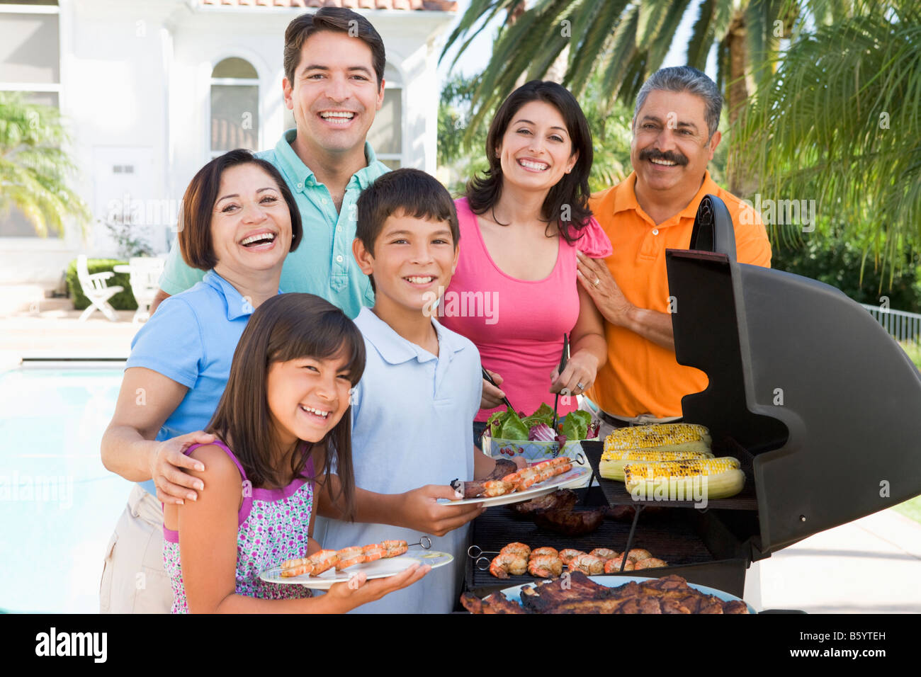 Family Enjoying A Barbeque Stock Photo - Alamy