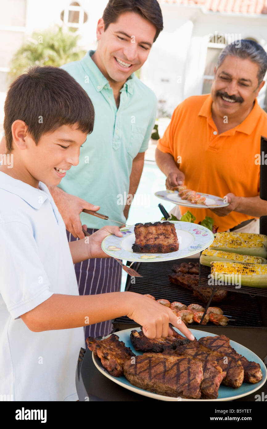 Family Enjoying A Barbeque Stock Photo - Alamy