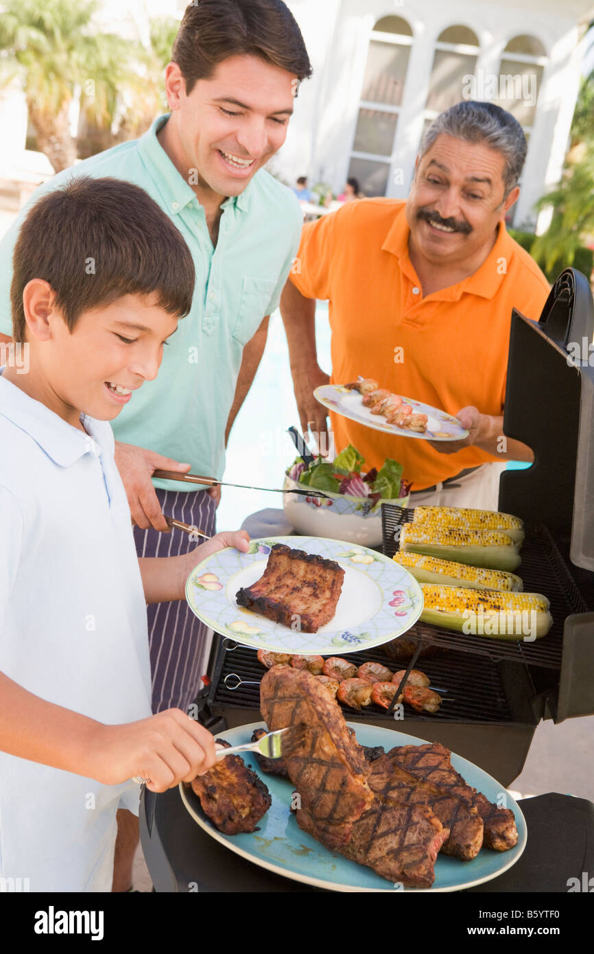 Family Enjoying A Barbeque Stock Photo - Alamy