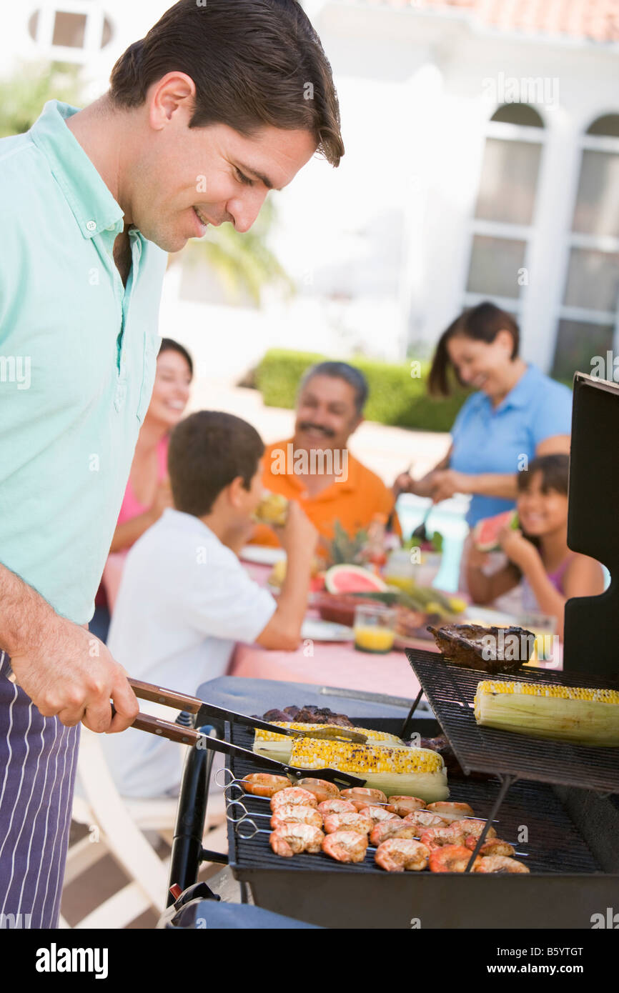 Family Enjoying A Barbeque Stock Photo - Alamy