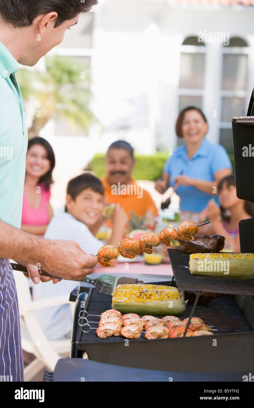 Family Enjoying A Barbeque Stock Photo - Alamy