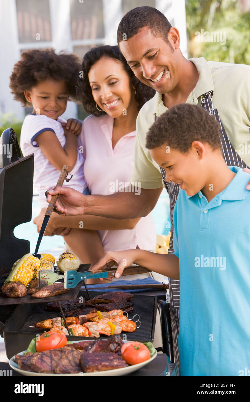 Family Enjoying A Barbeque Stock Photo - Alamy