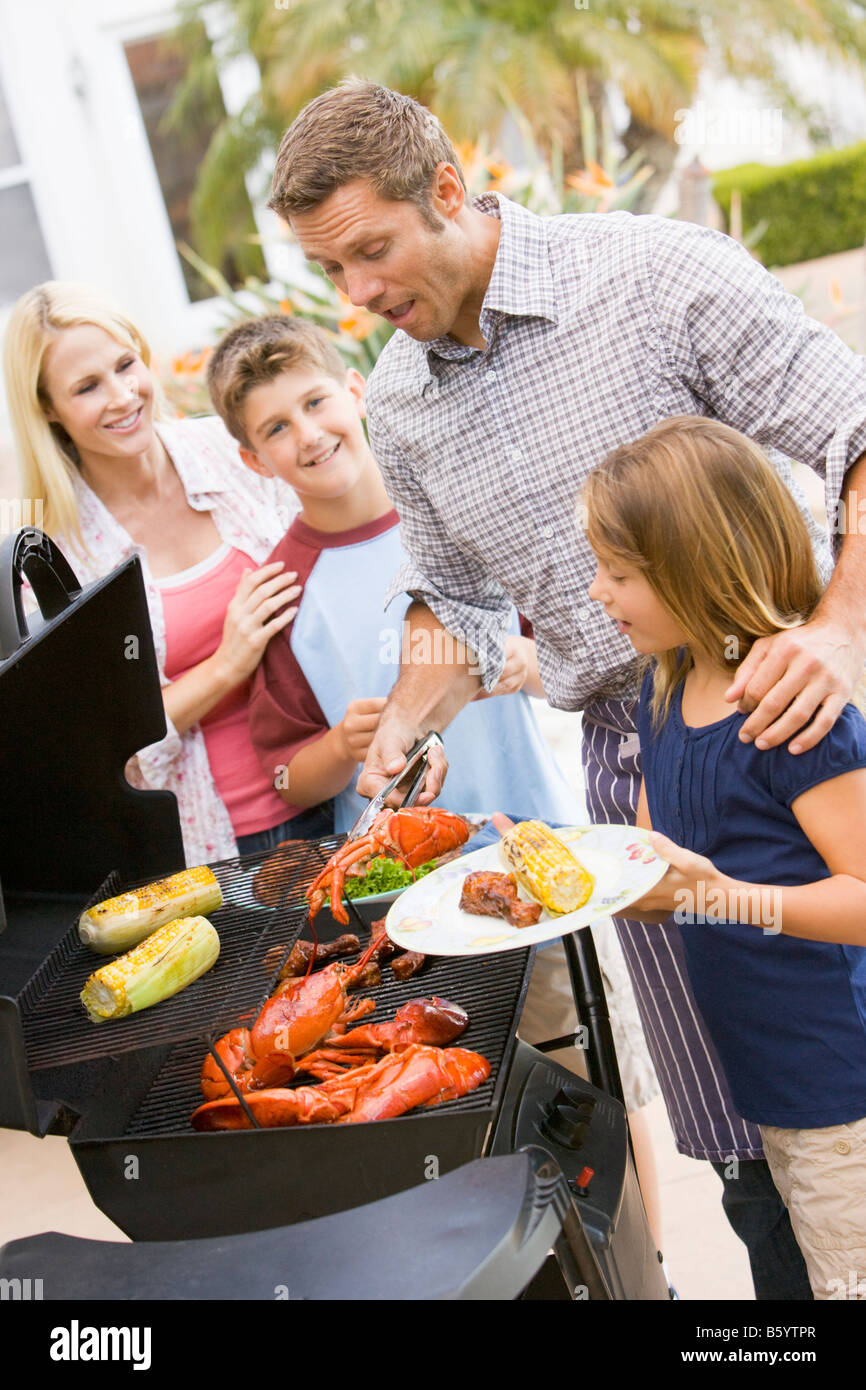 Family Enjoying A Barbeque Stock Photo - Alamy