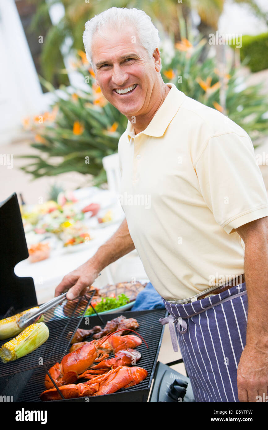 Man Barbequing In A Garden Stock Photo - Alamy