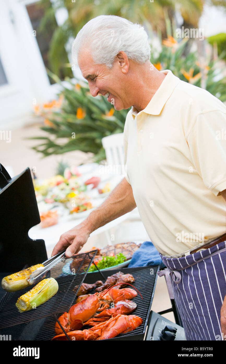 Man Barbequing In A Garden Stock Photo - Alamy