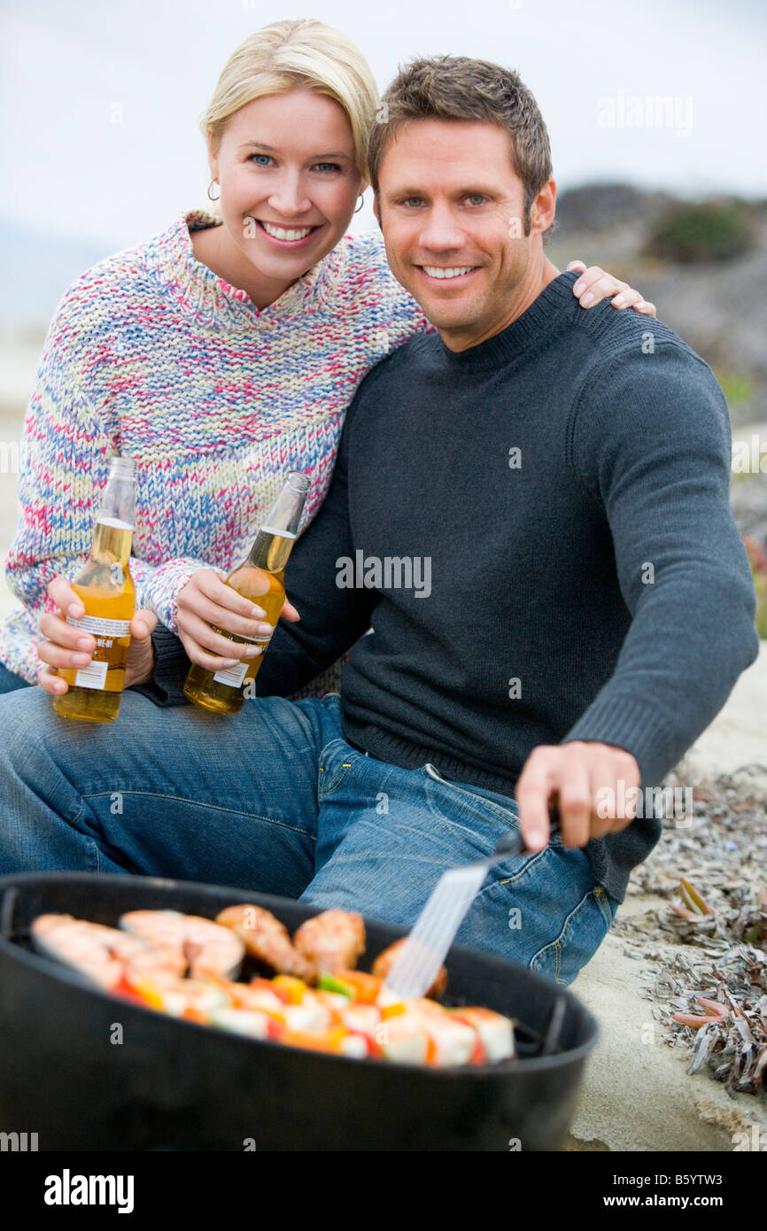 Couple Cooking On A Barbeque Stock Photo - Alamy