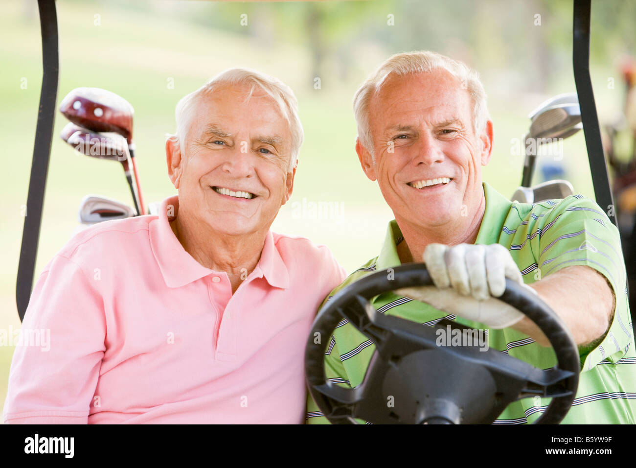 Male Friends Enjoying A Game Of Golf Stock Photo - Alamy
