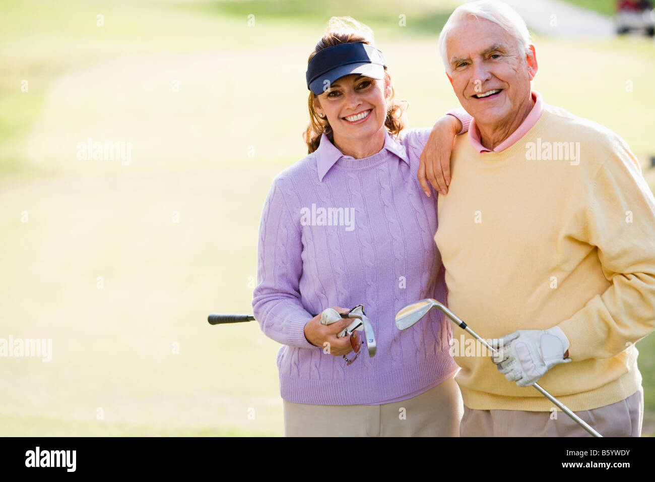 Couple Enjoying A Game Of Golf Stock Photo - Alamy