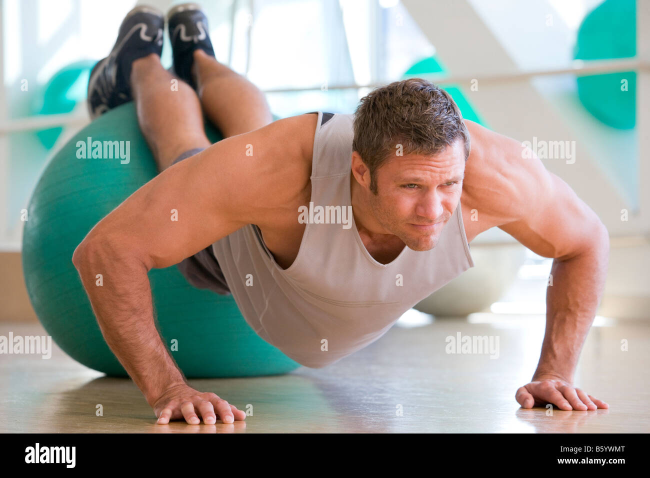 Man Balancing On Swiss Ball At Gym Stock Photo - Alamy