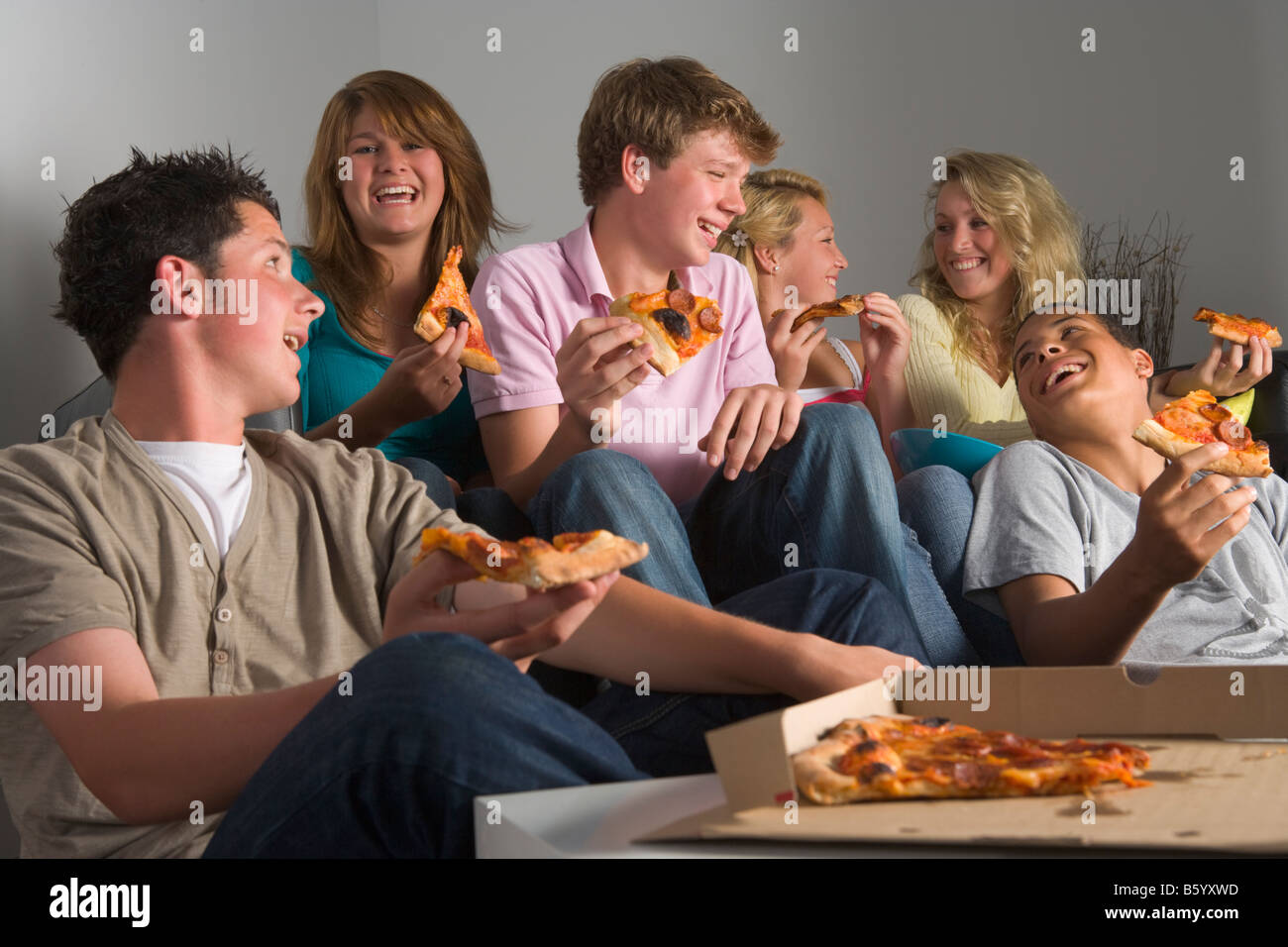 Teenagers Having Fun And Eating Pizza Stock Photo - Alamy