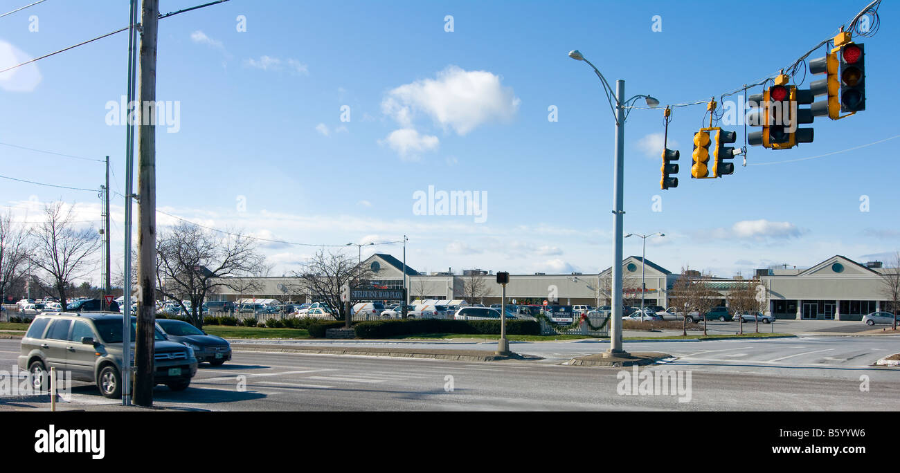 Typical American shopping center or strip mall wide view with traffic ...