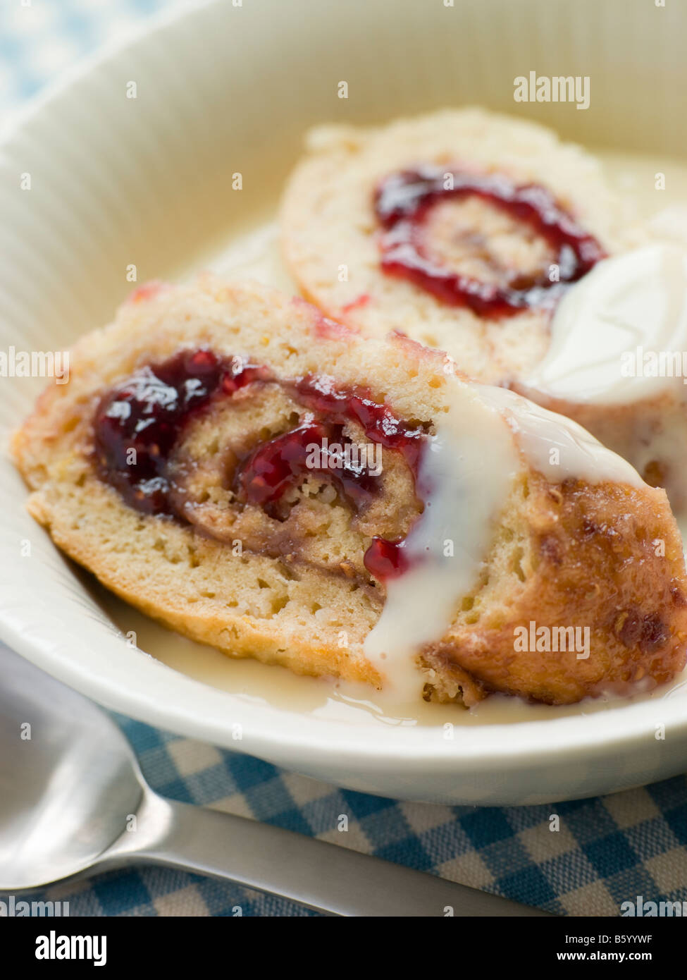 Bowl of Jam Roly Poly and Custard Stock Photo - Alamy