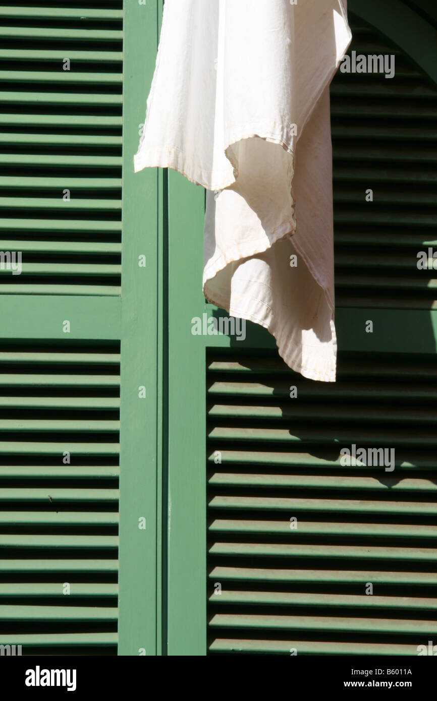 white sheet hanging from window in sun in italy Stock Photo - Alamy