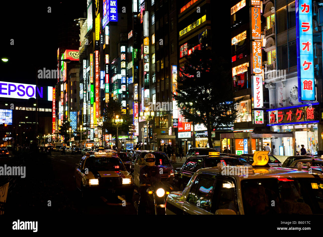 Traffic and neon signs in the streets of Shinjuku at night, Tokyo ...