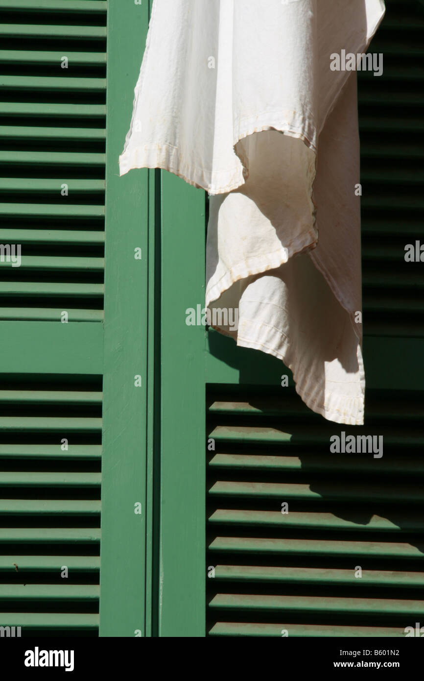 white sheet hanging from window in sun in italy Stock Photo - Alamy